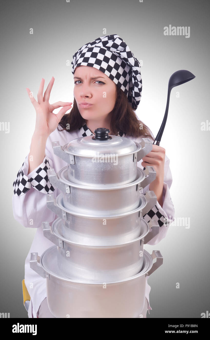 Cook with stack of pots on white Stock Photo - Alamy
