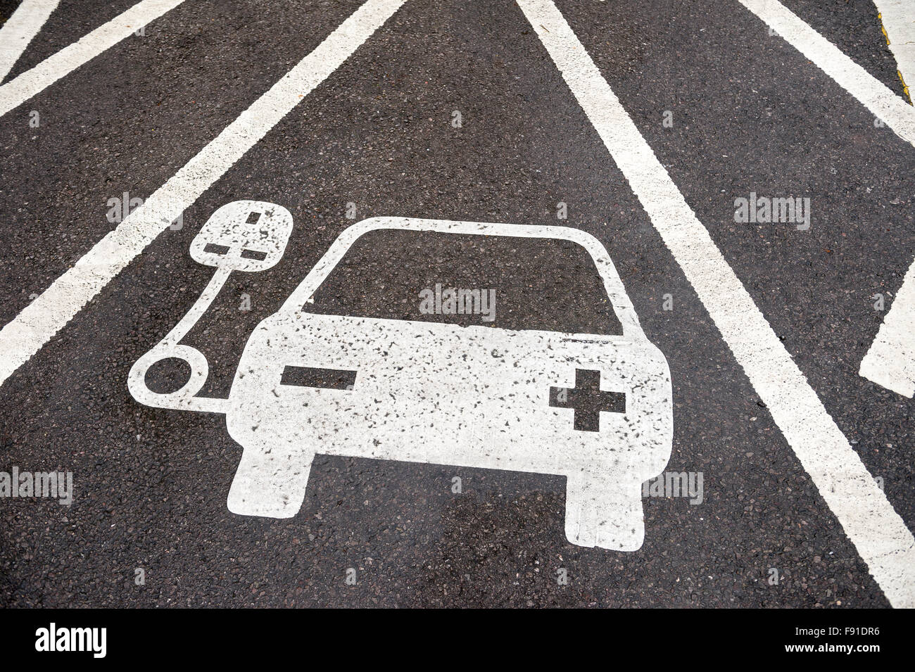 Electric vehicle charging station sign in a parking bay painted on ...