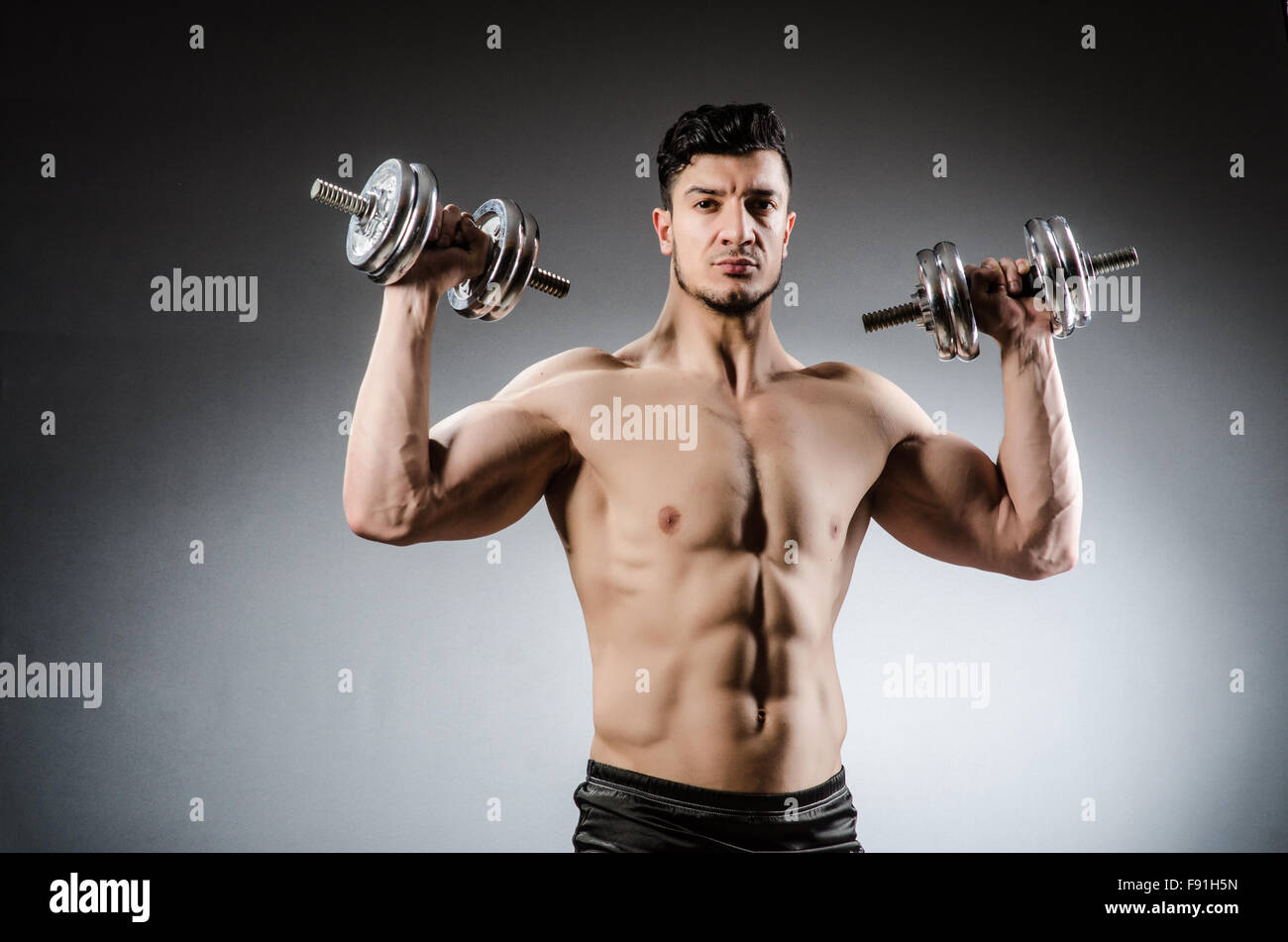 Muscular ripped bodybuilder with dumbbells Stock Photo - Alamy