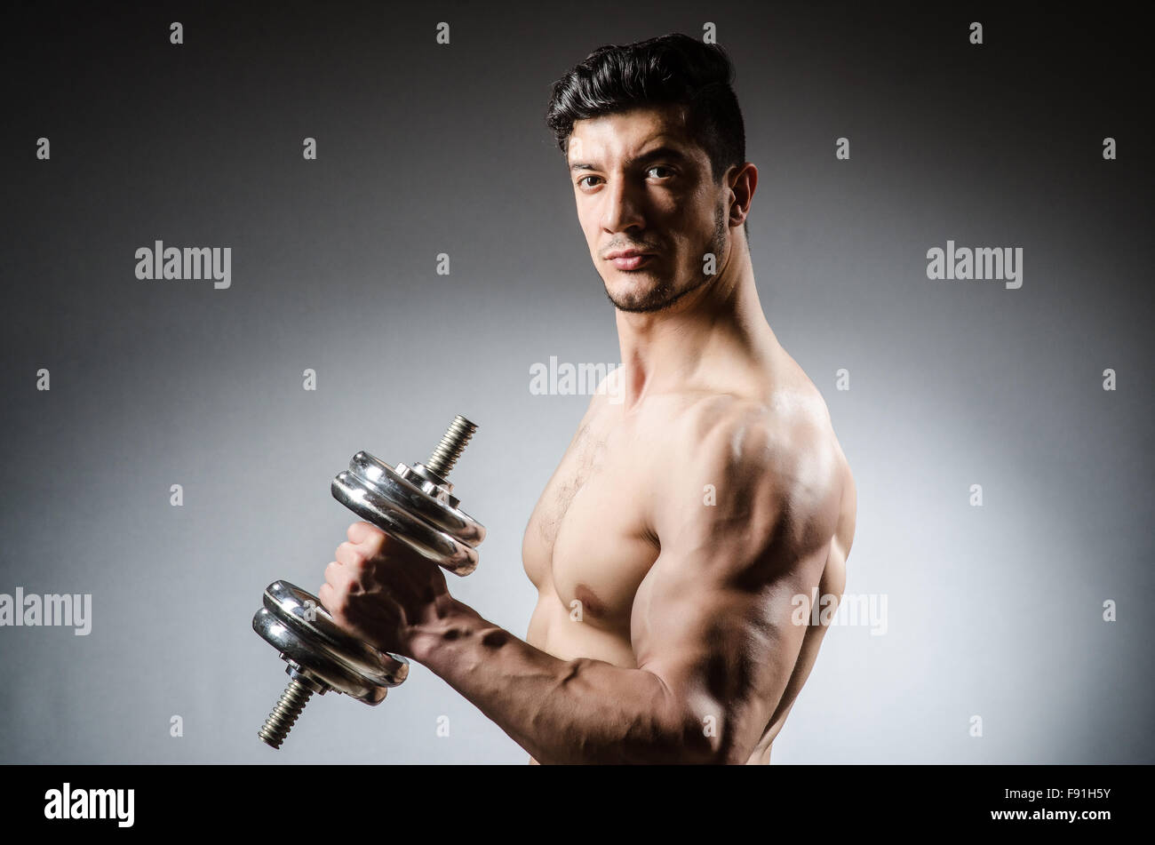 Muscular ripped bodybuilder with dumbbells Stock Photo - Alamy