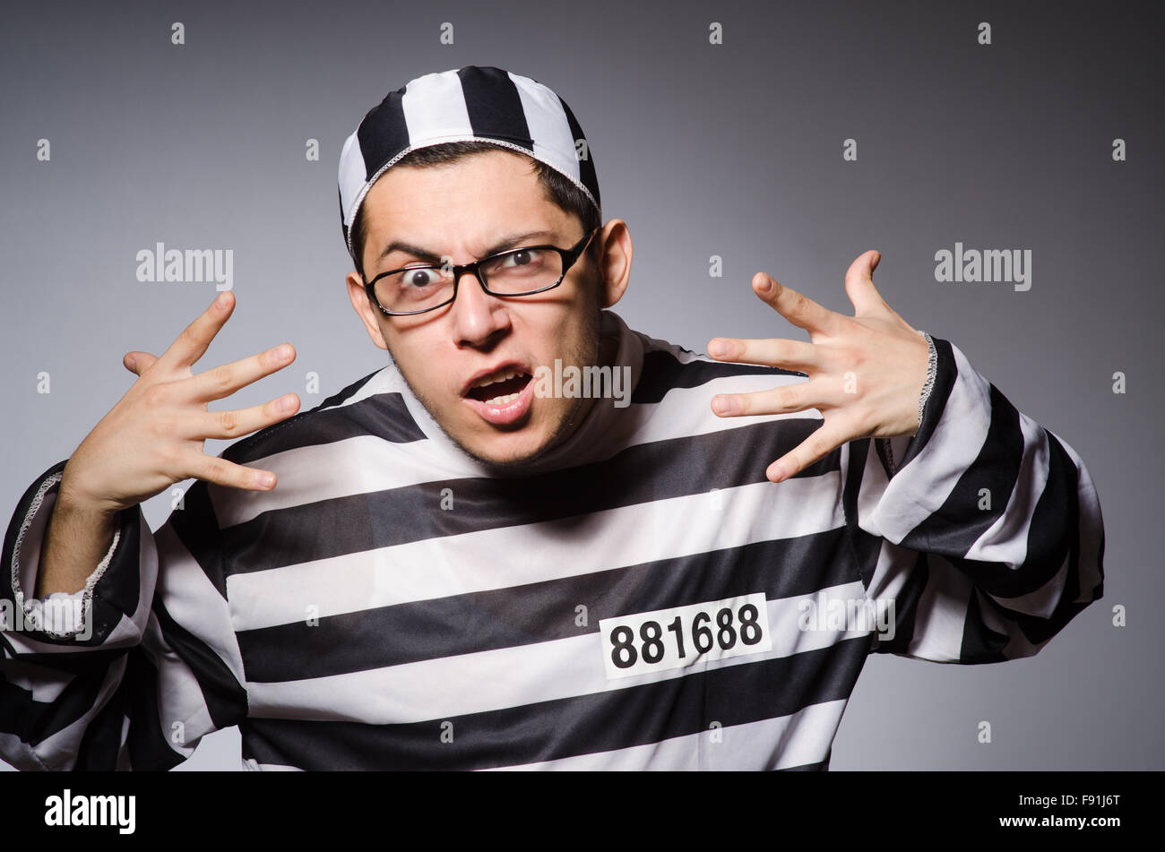 Funny prisoner isolated on gray Stock Photo - Alamy