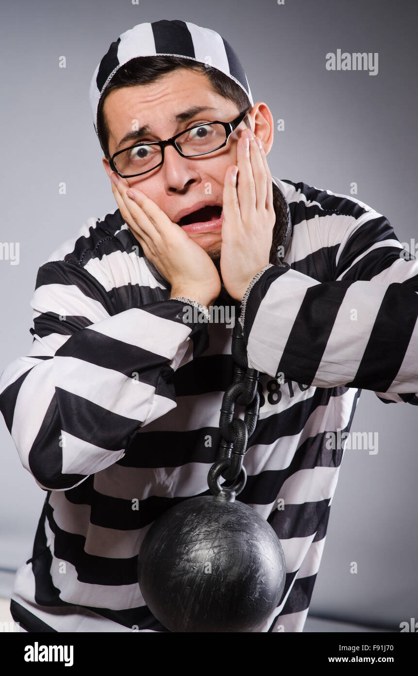 Funny prisoner in chains isolated on gray Stock Photo - Alamy