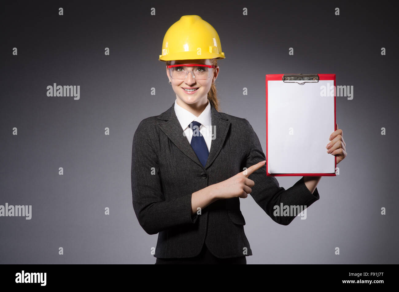 Female engineer with helmet isolated on gray Stock Photo - Alamy