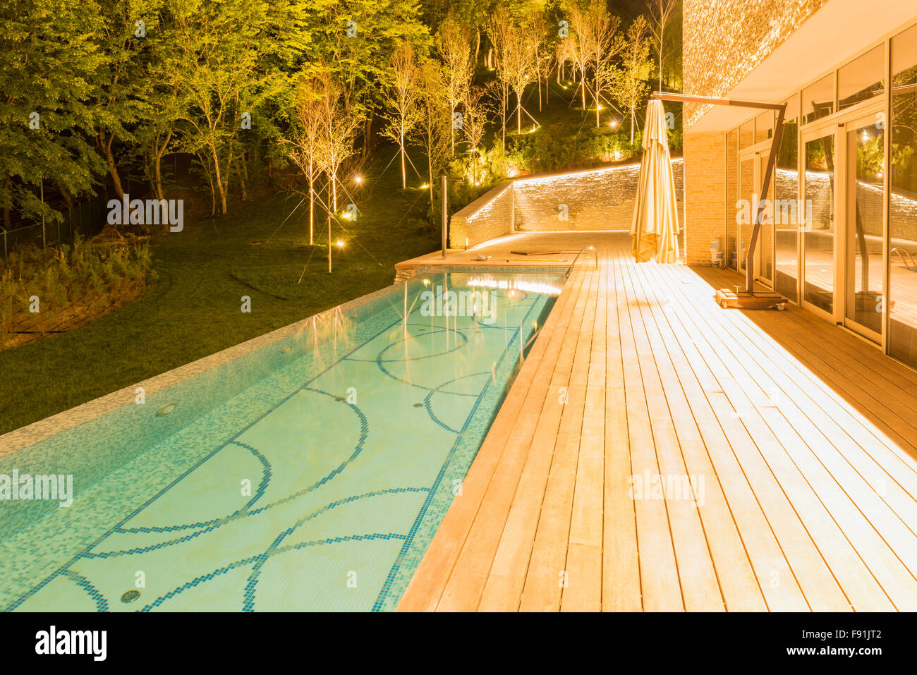 Swimming pool at night time Stock Photo - Alamy