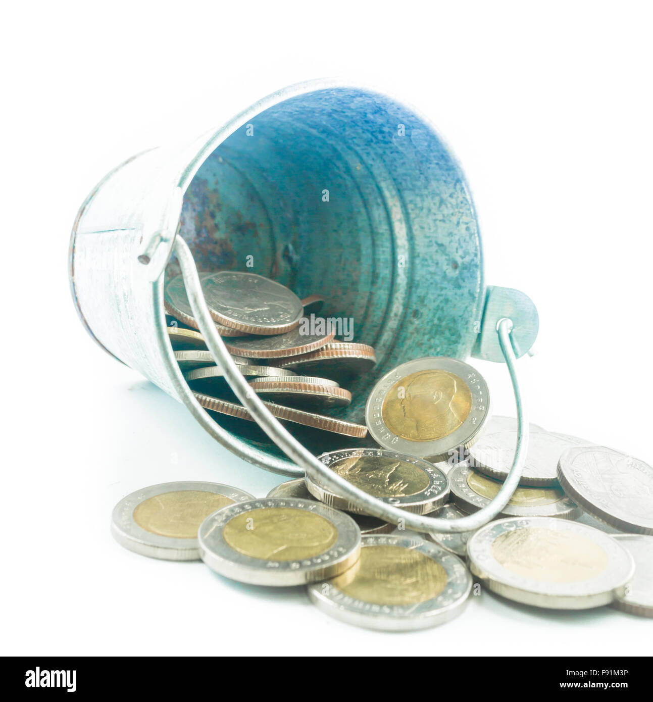 Thai baht coins on a small metal bucket on a white background, stock ...