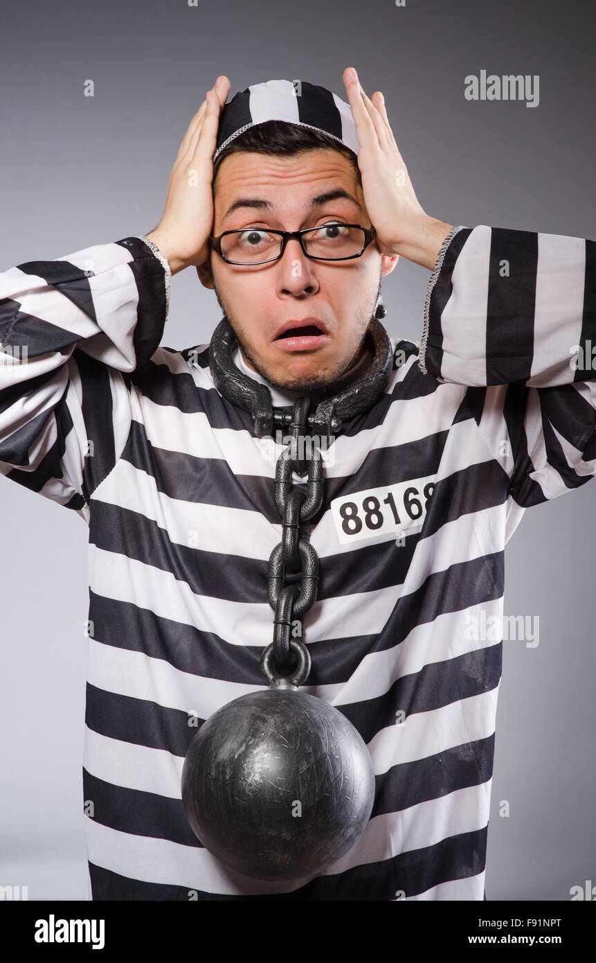 Funny prisoner in chains isolated on gray Stock Photo - Alamy