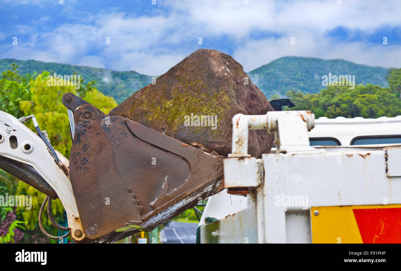 bobcat moving large rocks in the garden Stock Photo - Alamy
