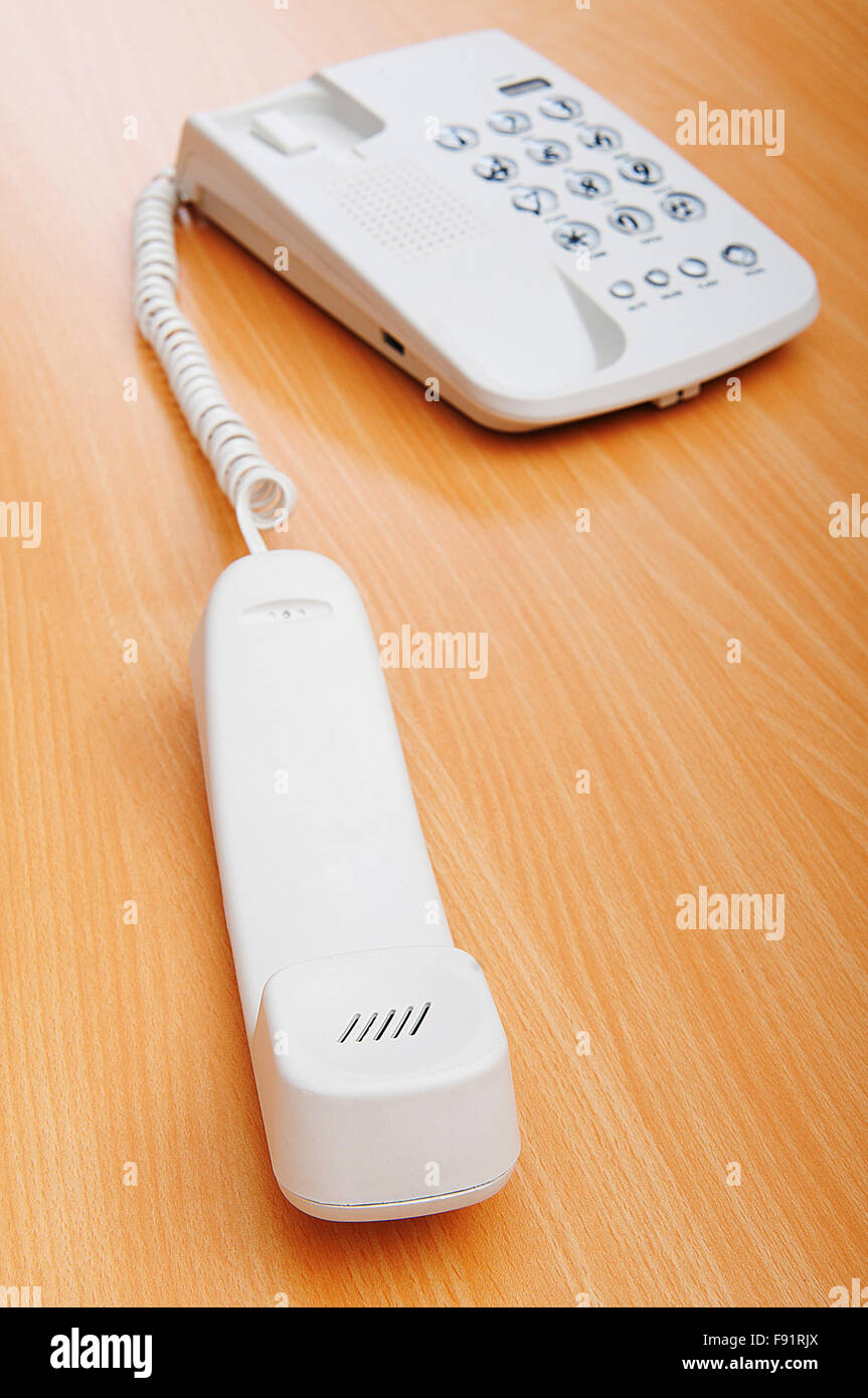 White office phone on the flat surface Stock Photo - Alamy