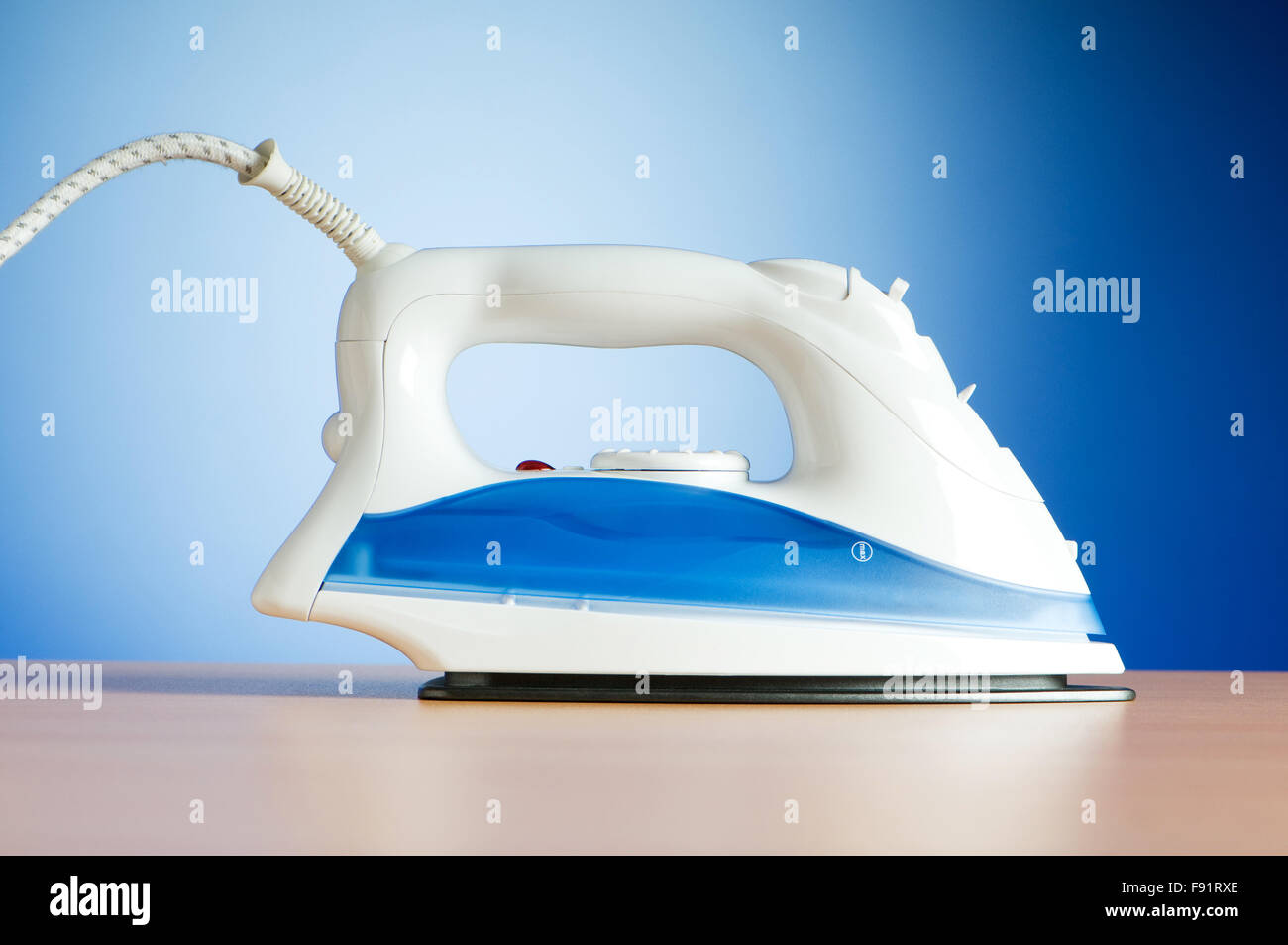 Modern electric iron against the colorful background Stock Photo - Alamy