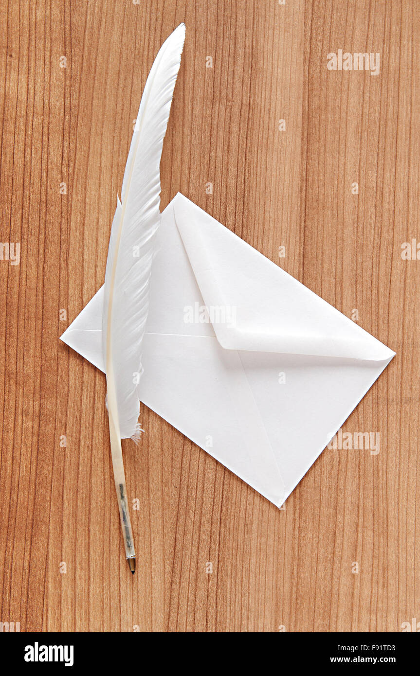 Writing feather and envelope Stock Photo - Alamy