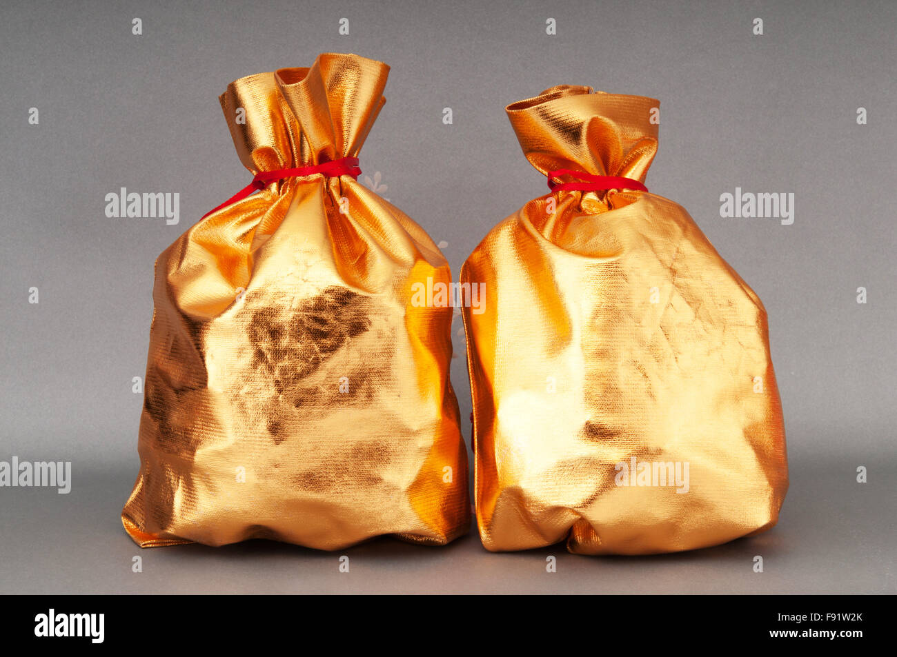 Golden sacks full of something good Stock Photo - Alamy