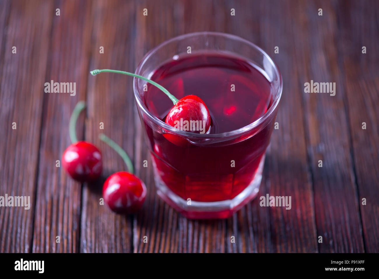 cherry drink in glass and on a table Stock Photo - Alamy