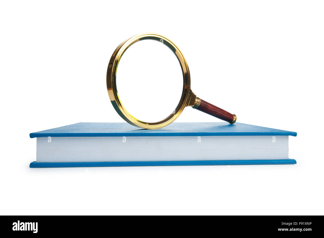 Magnifying glass over the stack of books Stock Photo - Alamy