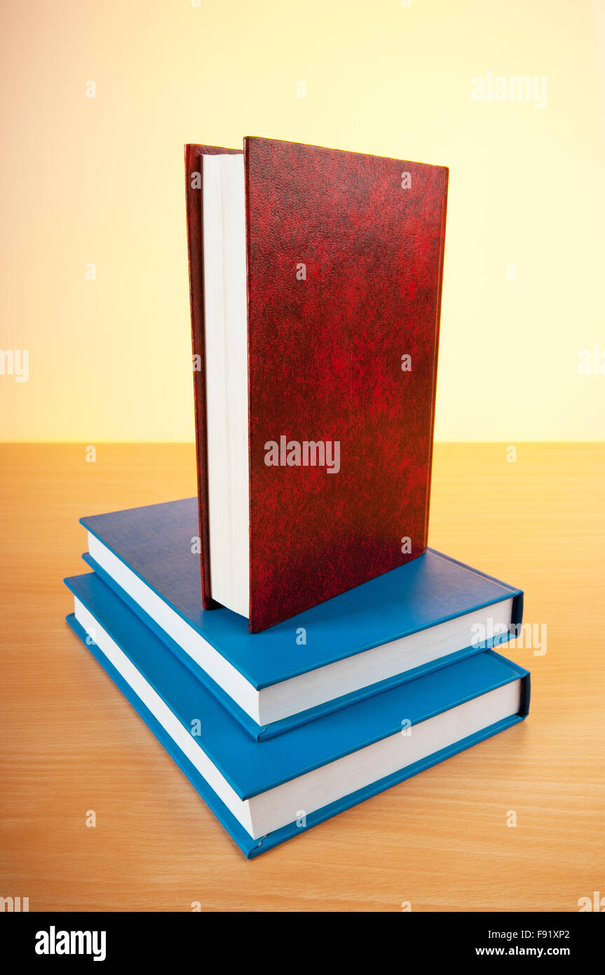 Stack of text books against gradient background Stock Photo - Alamy