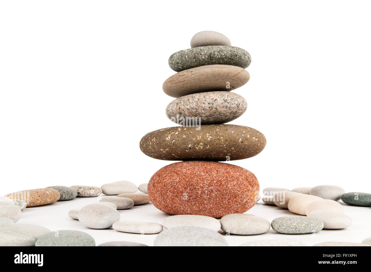 Stack of pebbles isolated on the white Stock Photo - Alamy