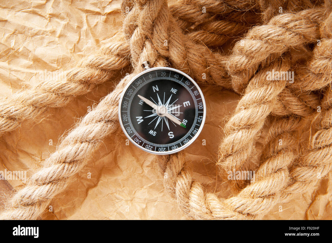 Compass and rope in travel and adventure concept Stock Photo - Alamy
