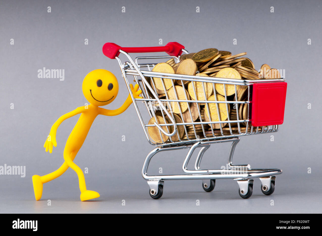 Smilies with shopping carts and coins Stock Photo - Alamy