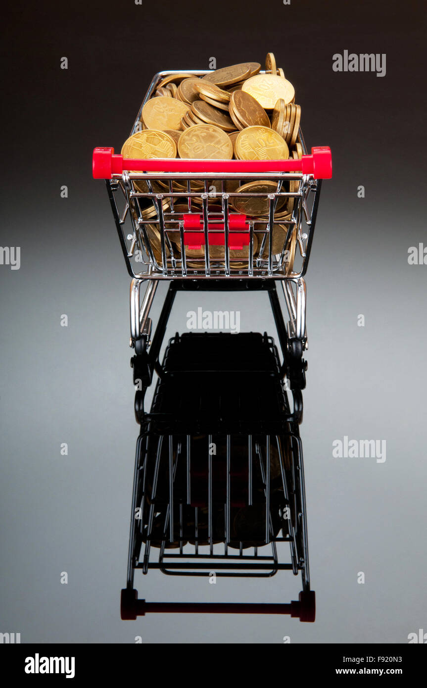 Shopping cart and gold coins Stock Photo - Alamy