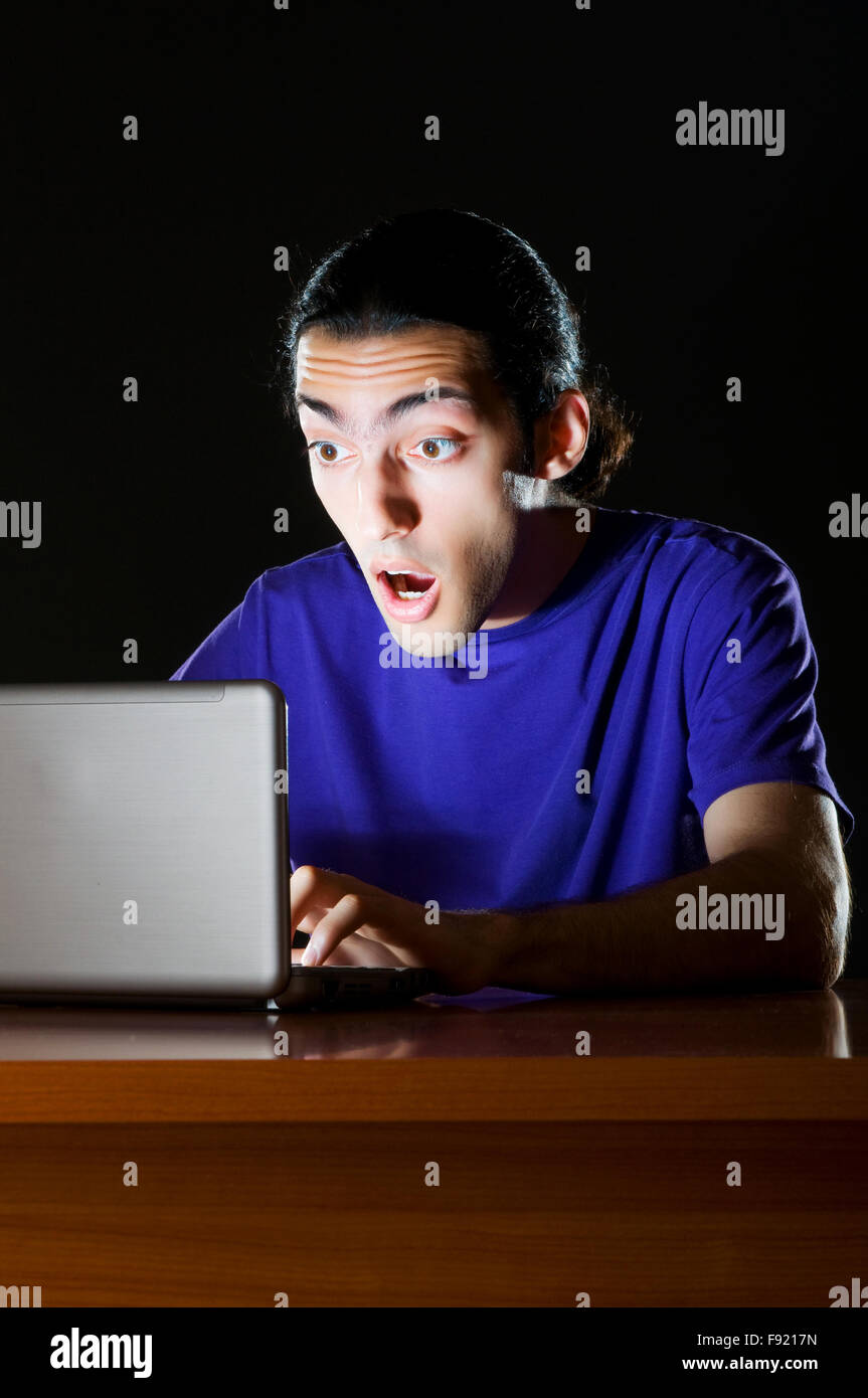 Hacker sitting in dark room Stock Photo - Alamy