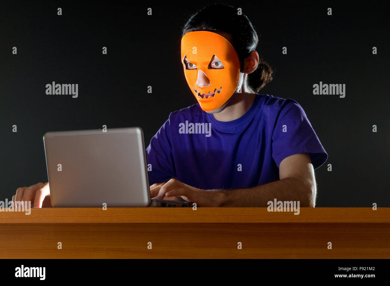 Hacker sitting in dark room Stock Photo - Alamy