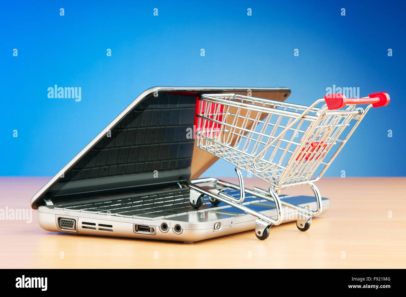 Shopping online with computer and cart Stock Photo - Alamy