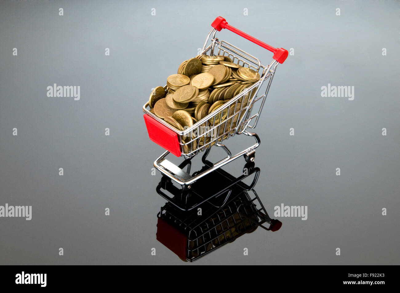 Shopping cart and gold coins Stock Photo - Alamy