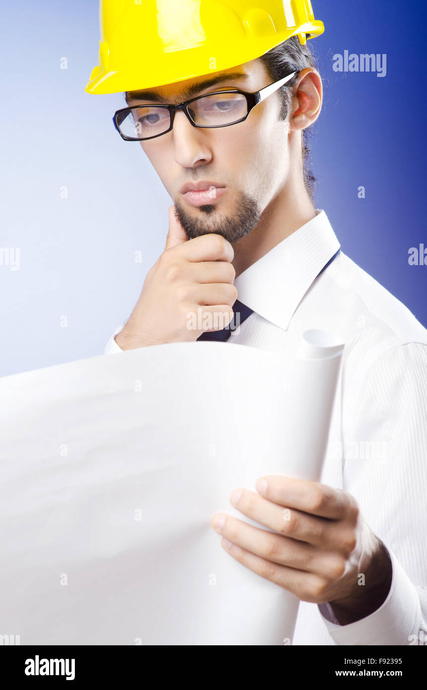 Young engineer looking at drawings Stock Photo - Alamy