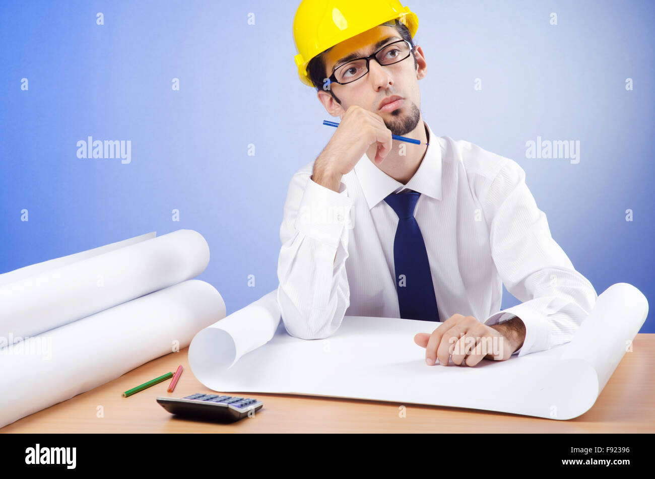 Young engineer looking at drawings Stock Photo - Alamy