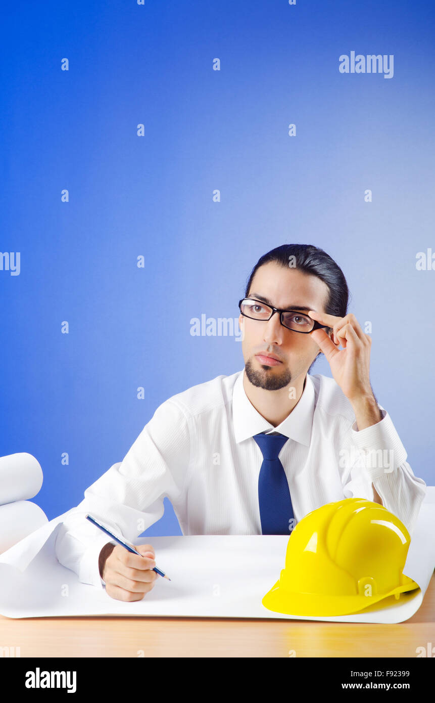 Young engineer looking at drawings Stock Photo - Alamy