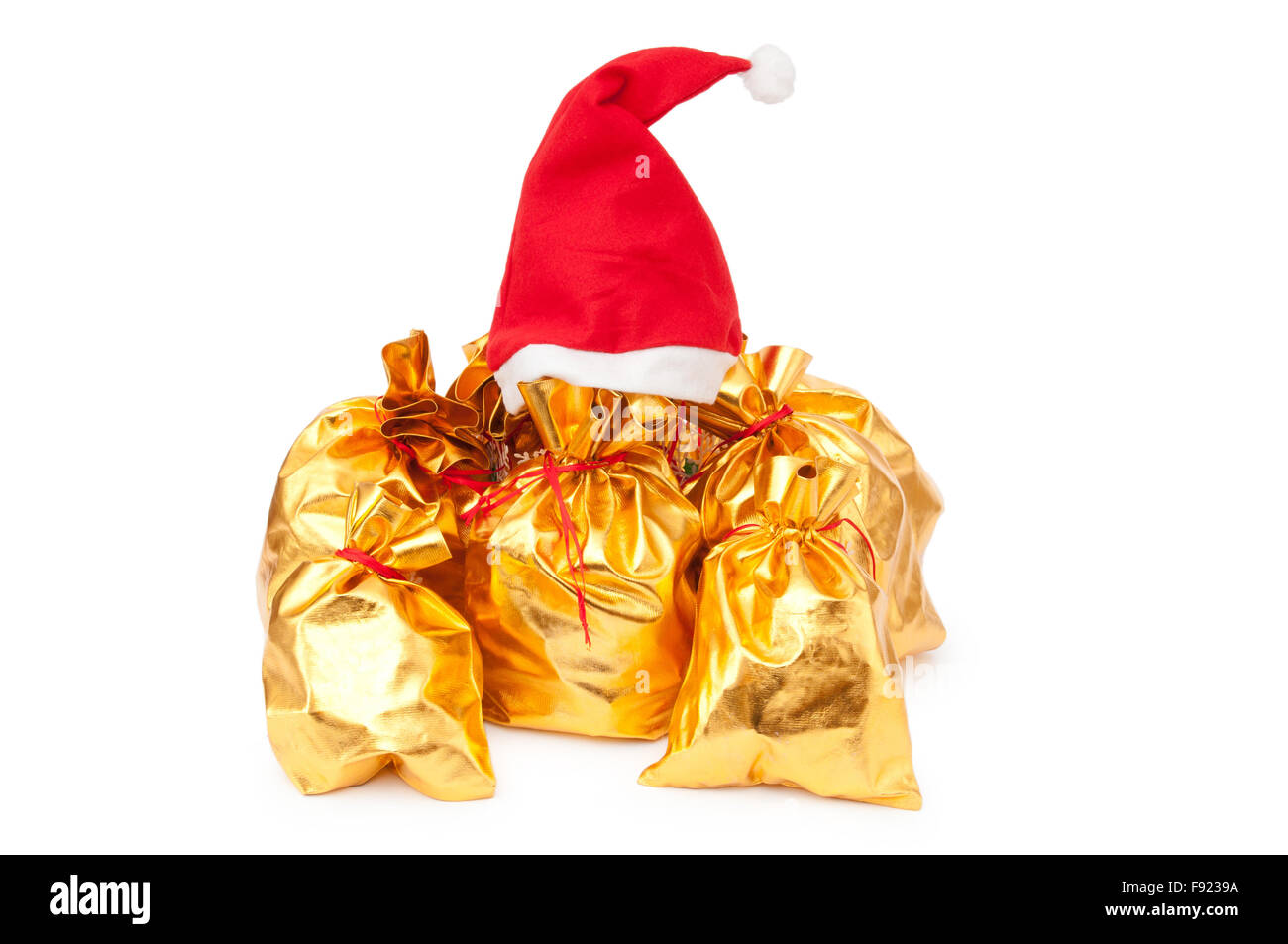 Golden sacks with santa hat Stock Photo - Alamy