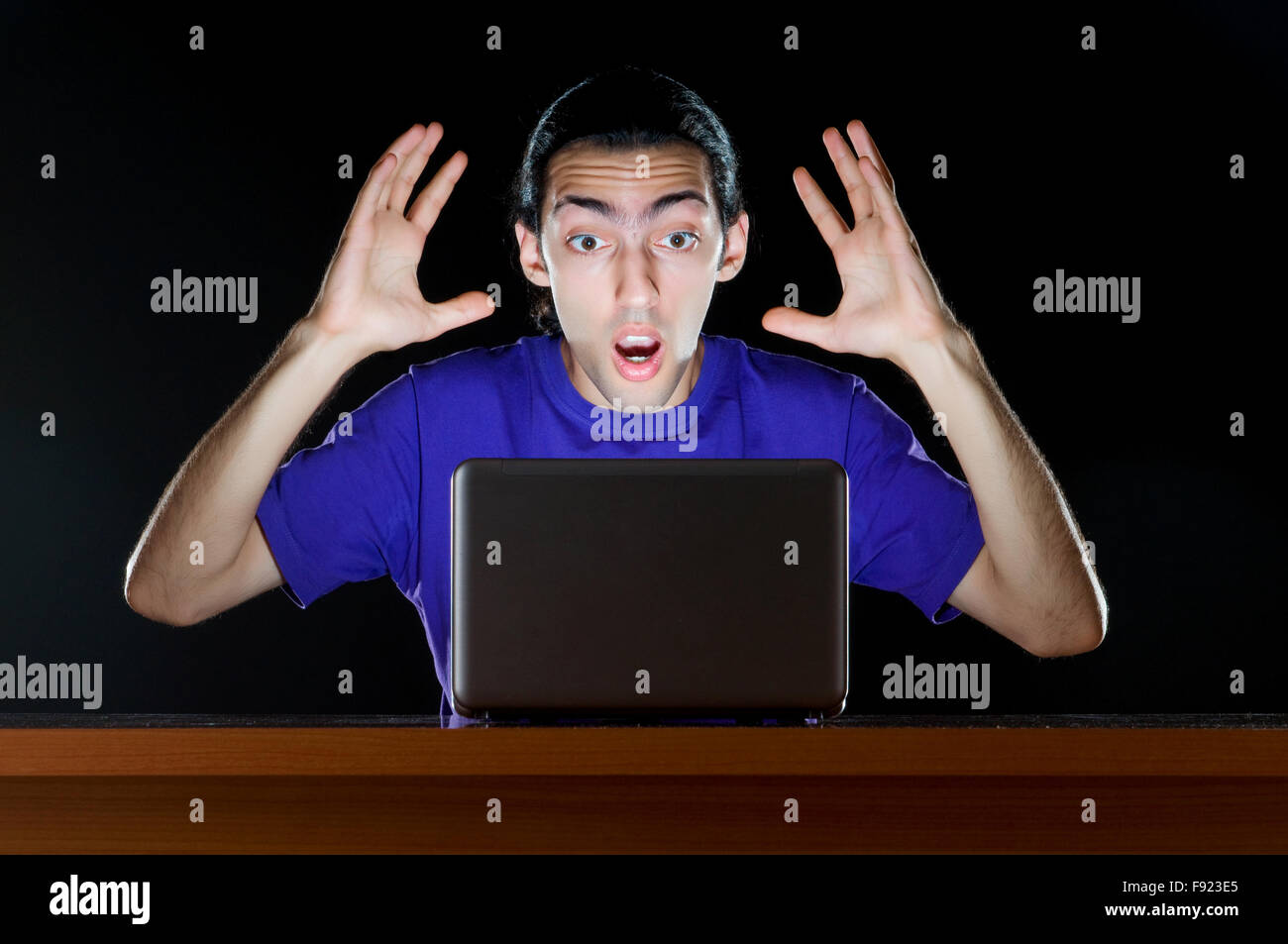 Hacker sitting in dark room Stock Photo - Alamy