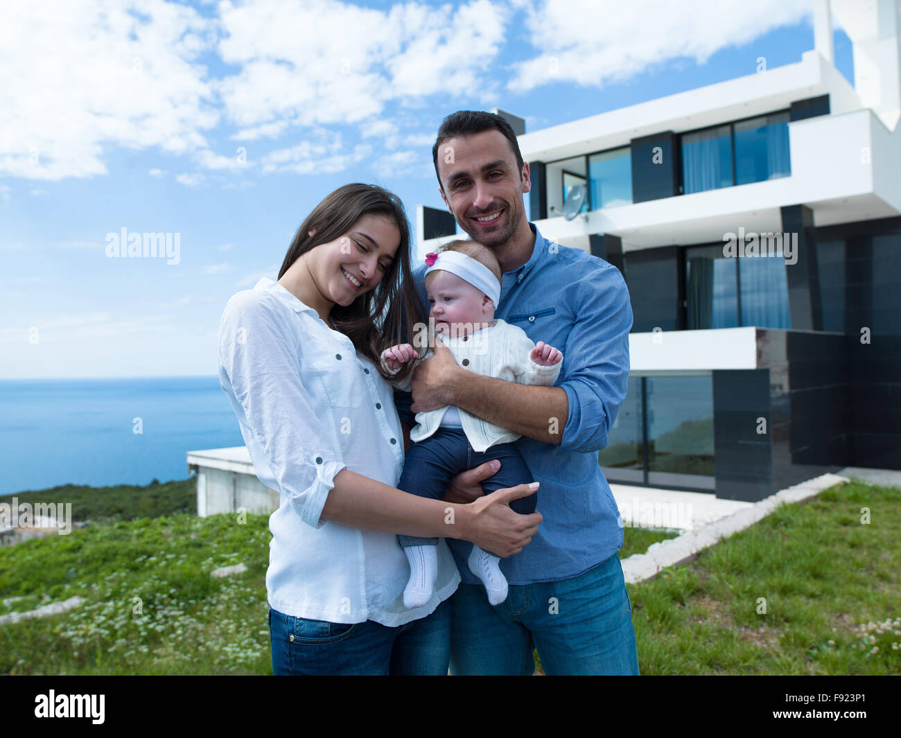 happy young family couple with beautiful new born baby have fun at ...