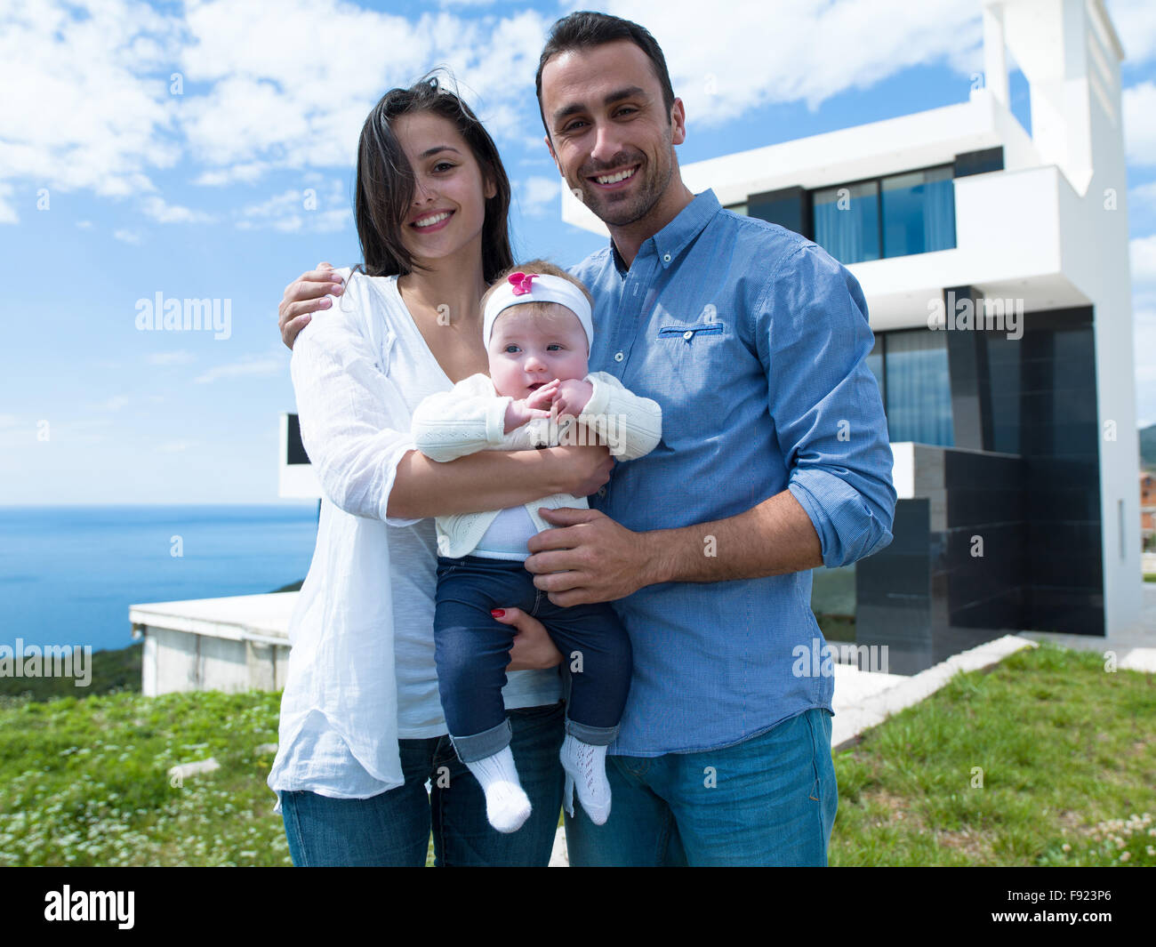 happy young family couple with beautiful new born baby have fun at ...