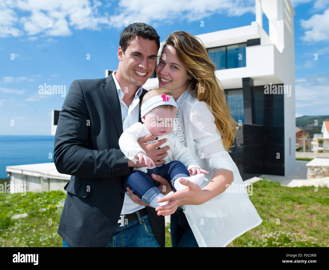 happy young family couple with beautiful new born baby have fun at ...