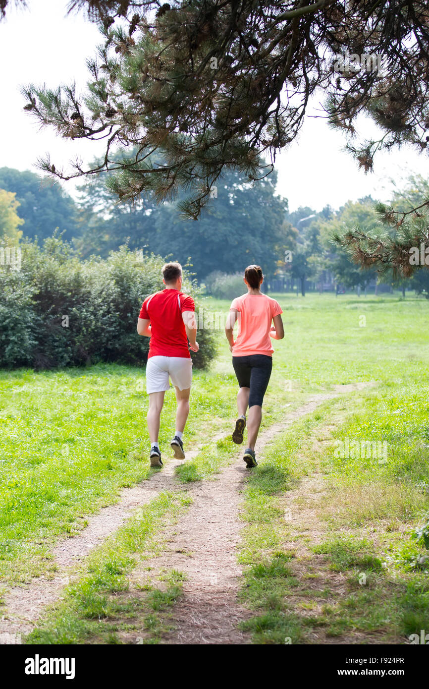 Young people running in the park Stock Photo - Alamy
