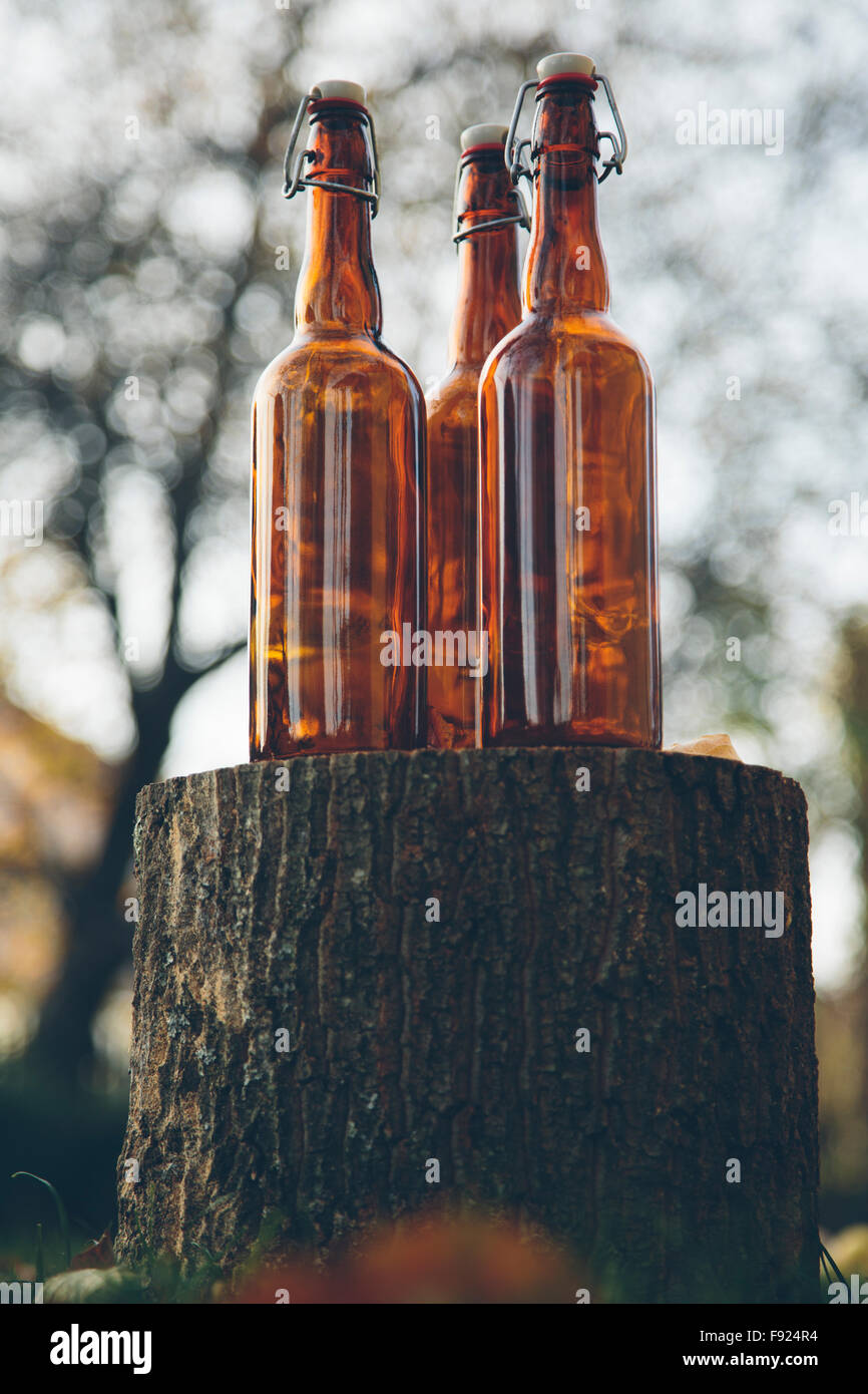 Glass bottles on wooden stack Stock Photo - Alamy