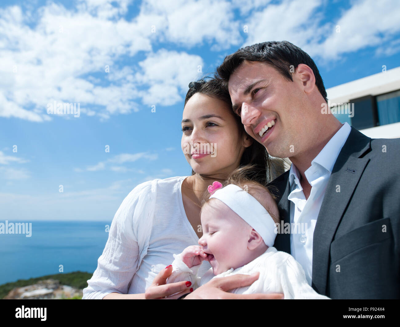 happy young family couple with beautiful new born baby have fun at ...