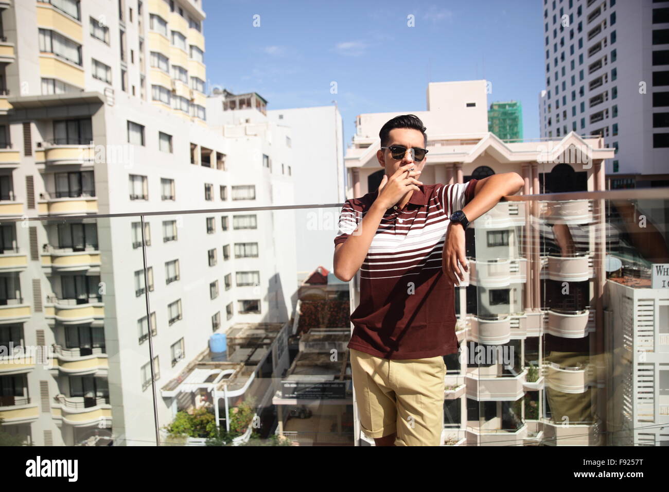 Smoking man on the balcony Stock Photo - Alamy