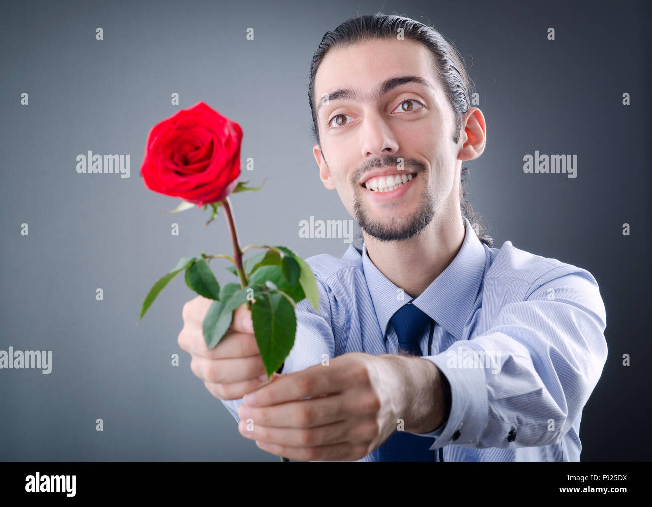 Young man with red rose Stock Photo - Alamy
