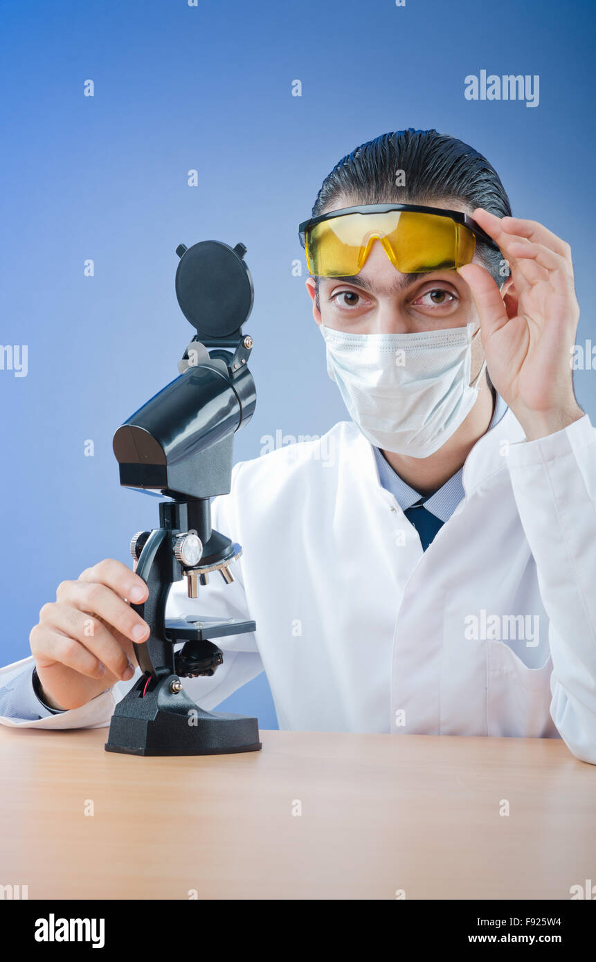 Chemist working with microscope Stock Photo - Alamy