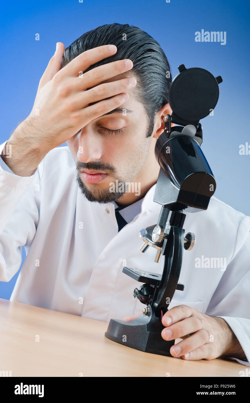 Chemist working with microscope Stock Photo - Alamy