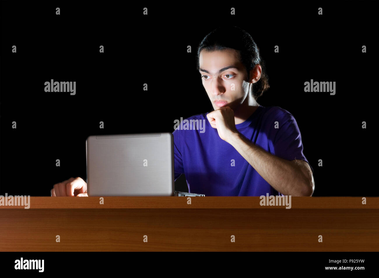 Hacker sitting in dark room Stock Photo - Alamy
