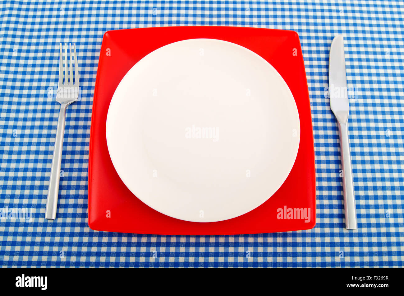 Empty plate with utensils Stock Photo - Alamy