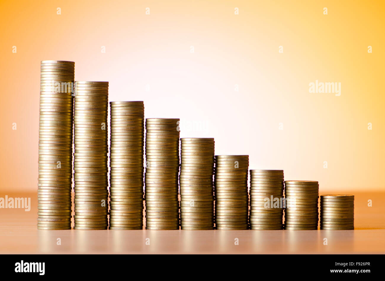 Golden coins in high stacks Stock Photo - Alamy