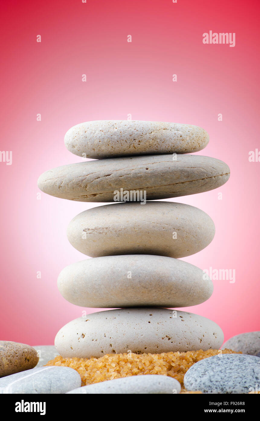 Balanced pebbles with colour background Stock Photo - Alamy
