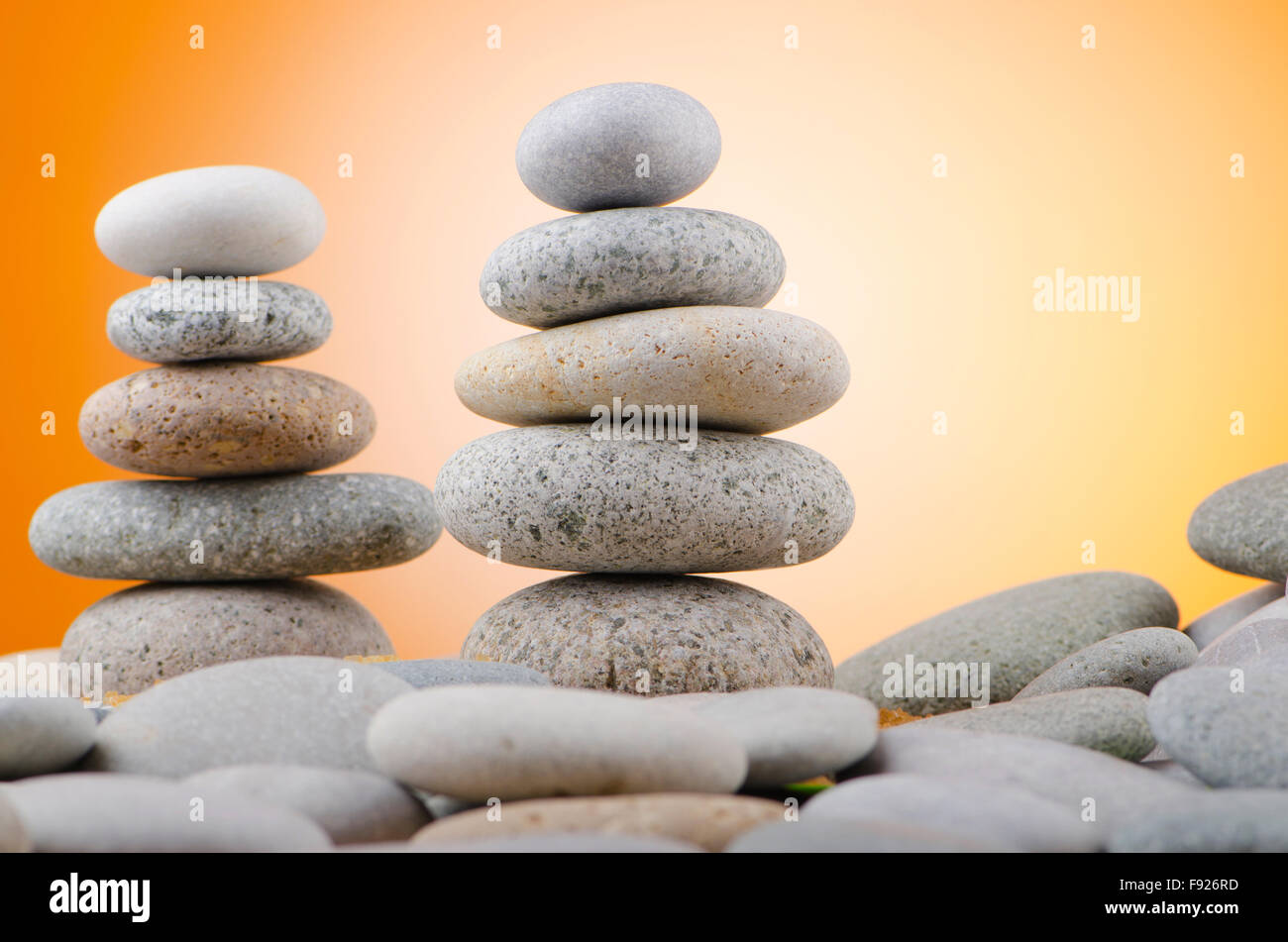 Balanced pebbles with colour background Stock Photo - Alamy