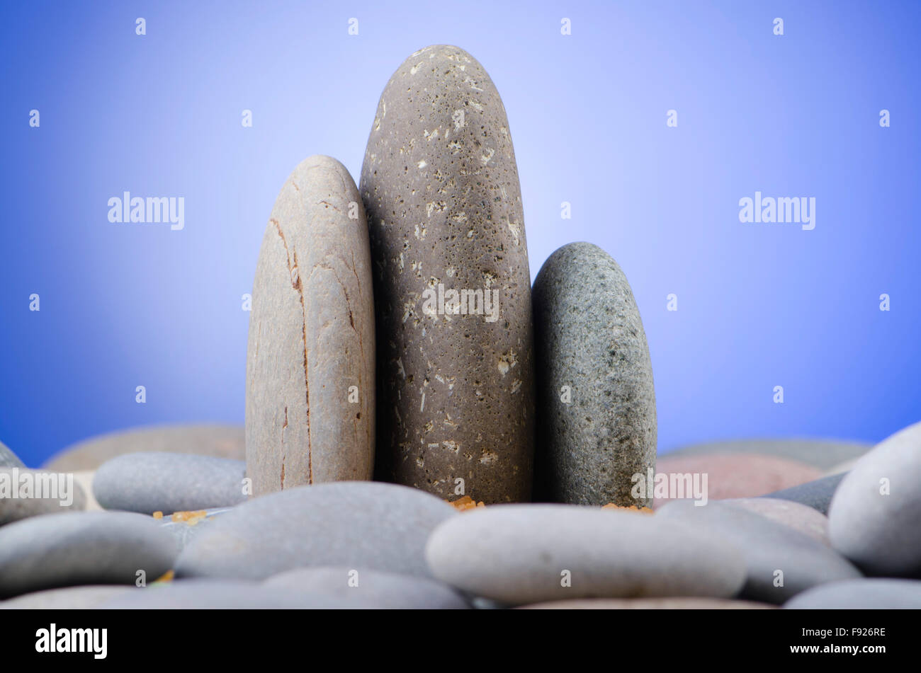 Balanced pebbles with colour background Stock Photo - Alamy