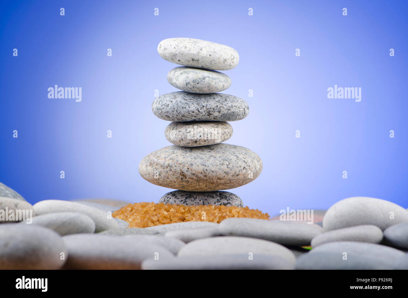 Balanced pebbles with colour background Stock Photo - Alamy