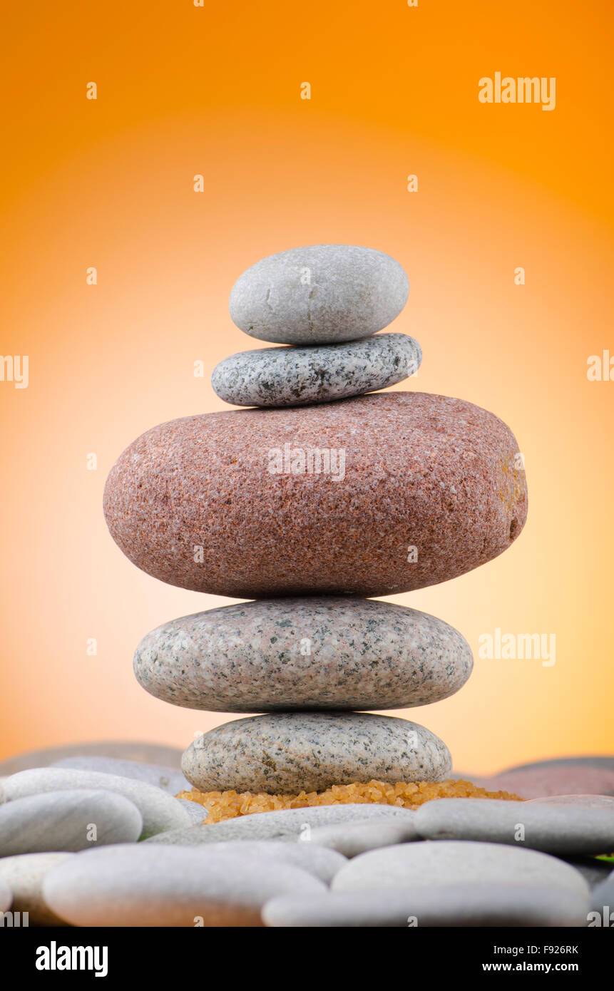 Balanced pebbles with colour background Stock Photo - Alamy