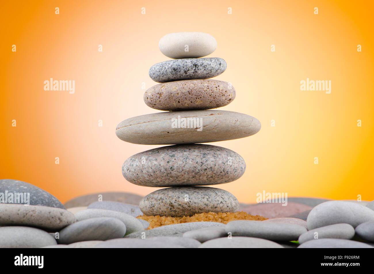 Balanced pebbles with colour background Stock Photo - Alamy